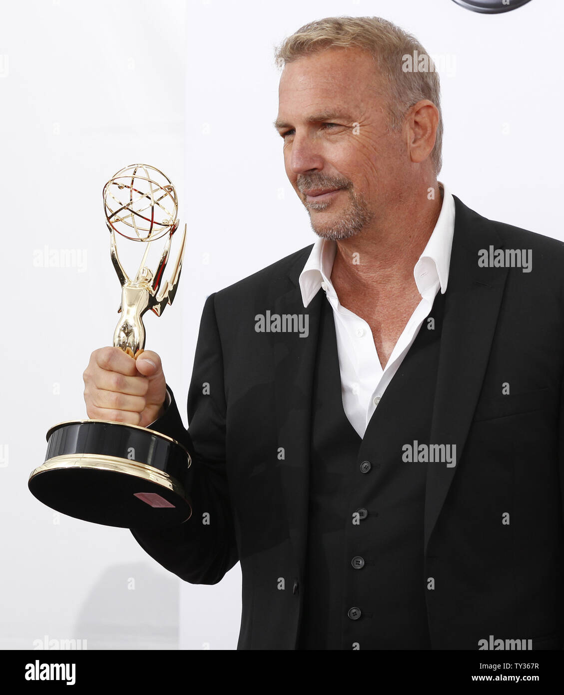 Kevin Costner holds the Emmy he won for 'Hatfields & McCoys' at the ...