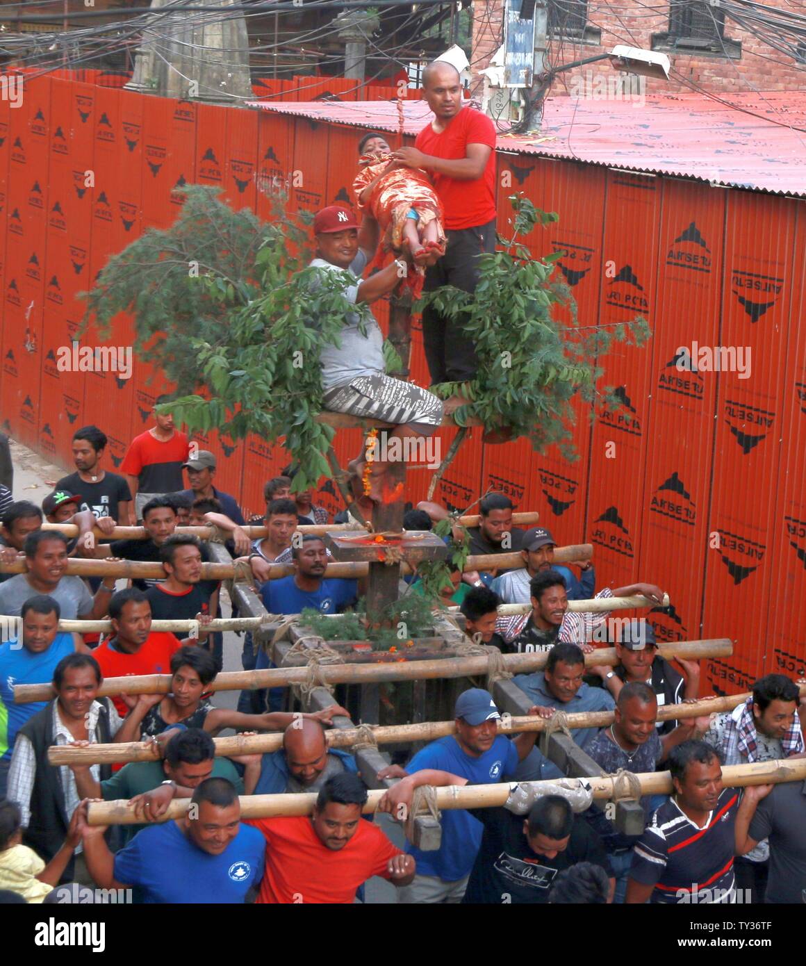 Kathmandu, Nepal. 25th June, 2019. A child is balanced above a prong ...