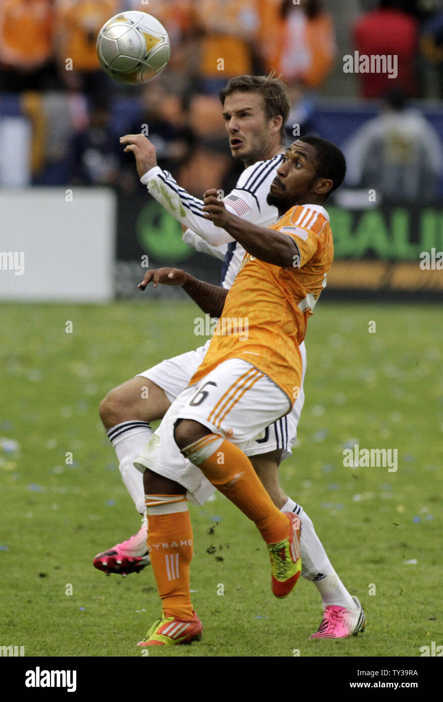 David Beckham and Houston's Corey Ashe battle for the ball as the Los ...