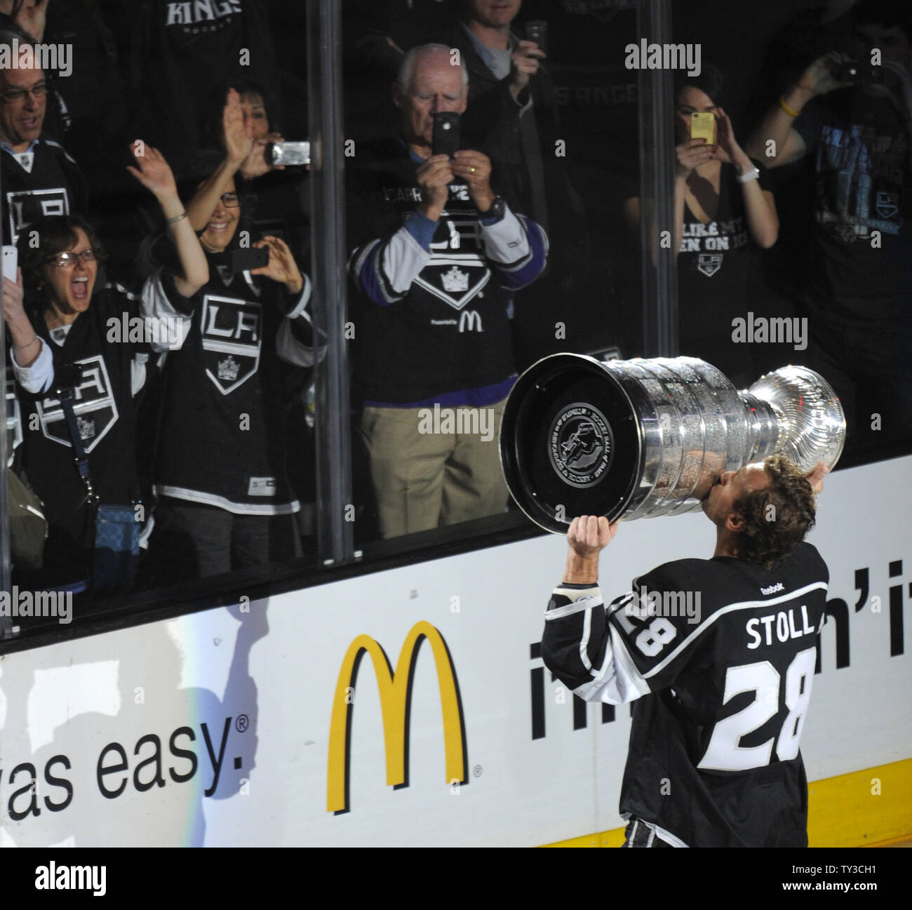 Los Angeles Kings center Jarret Stoll kisses the Stanley Cup in a ...