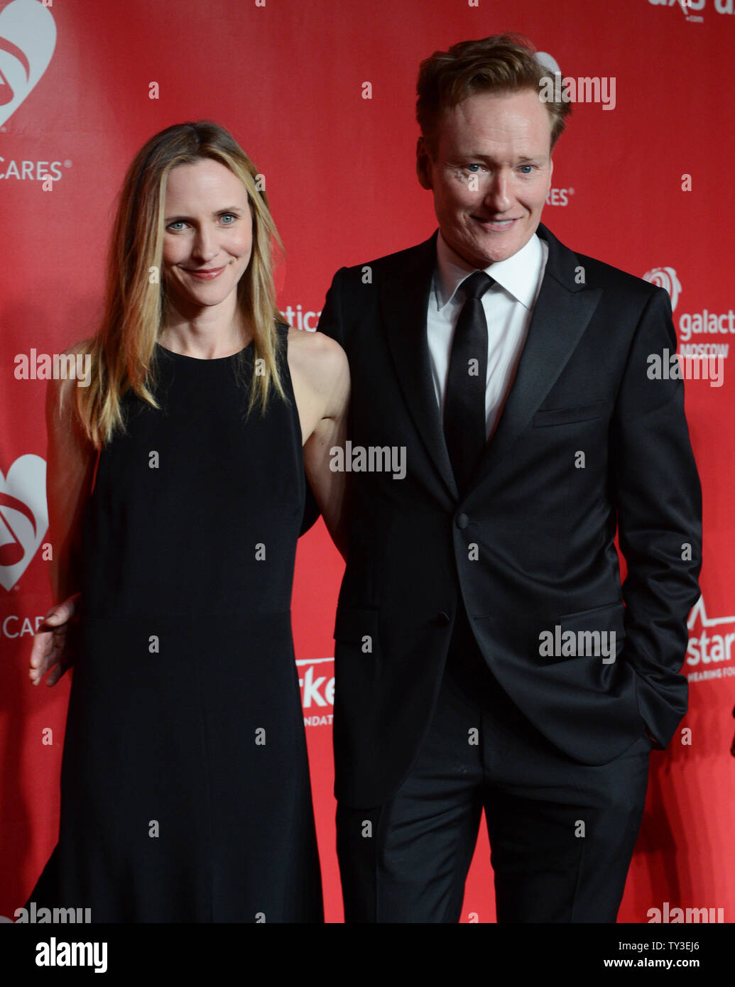 TV host Conan O'Brien (R) and his wife Liza Powel arrive at the 2013 ...
