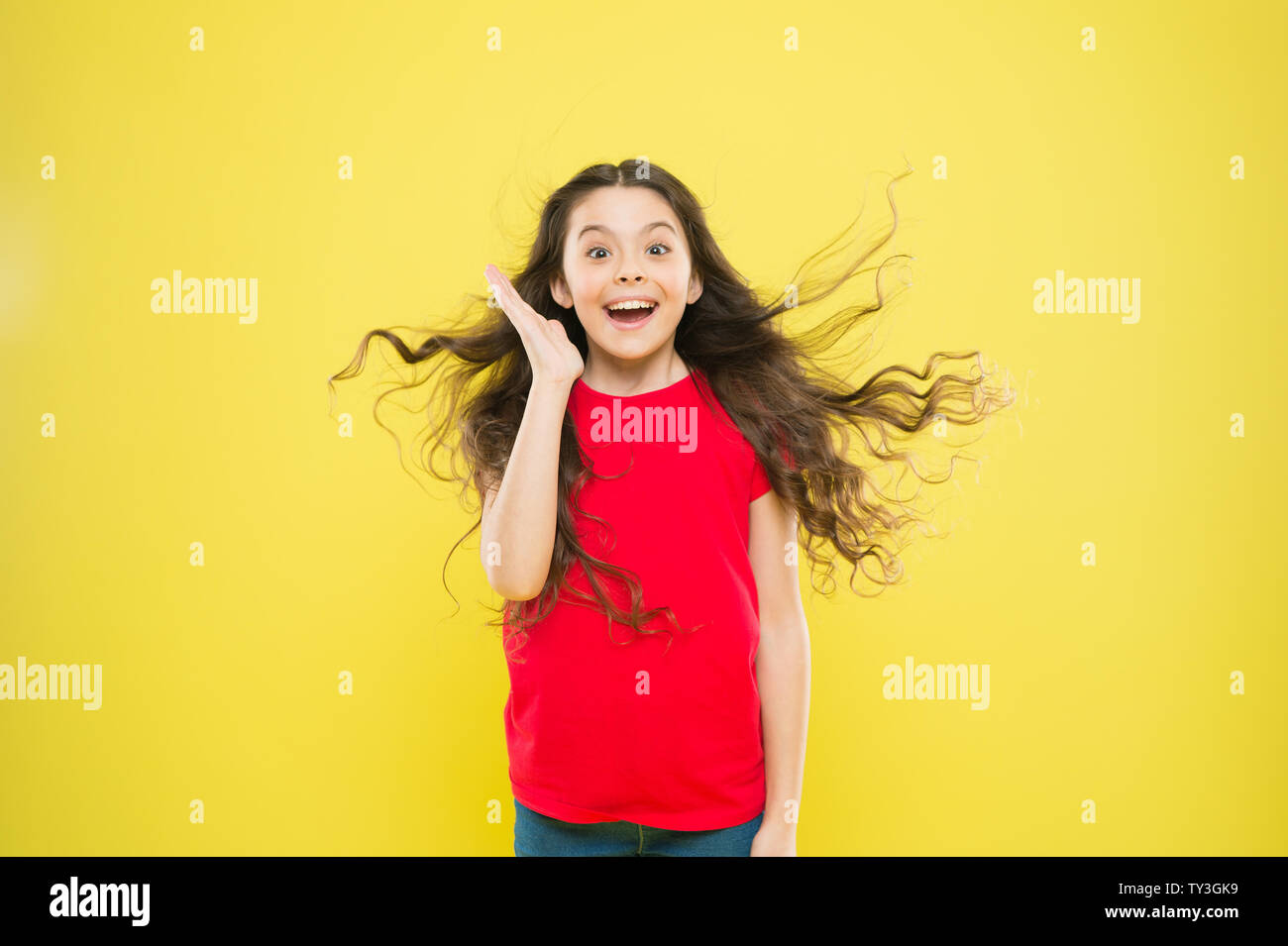 What a happy surprise. Surprised girl on yellow background. Adorable ...