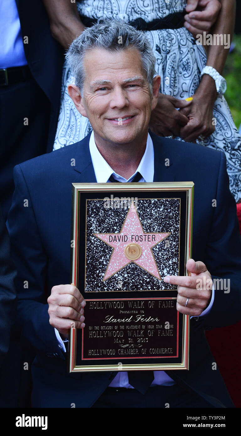 David Foster holds a replica plaque during an unveiling ceremony ...