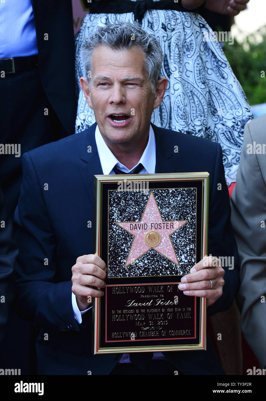 David Foster holds a replica plaque during an unveiling ceremony ...