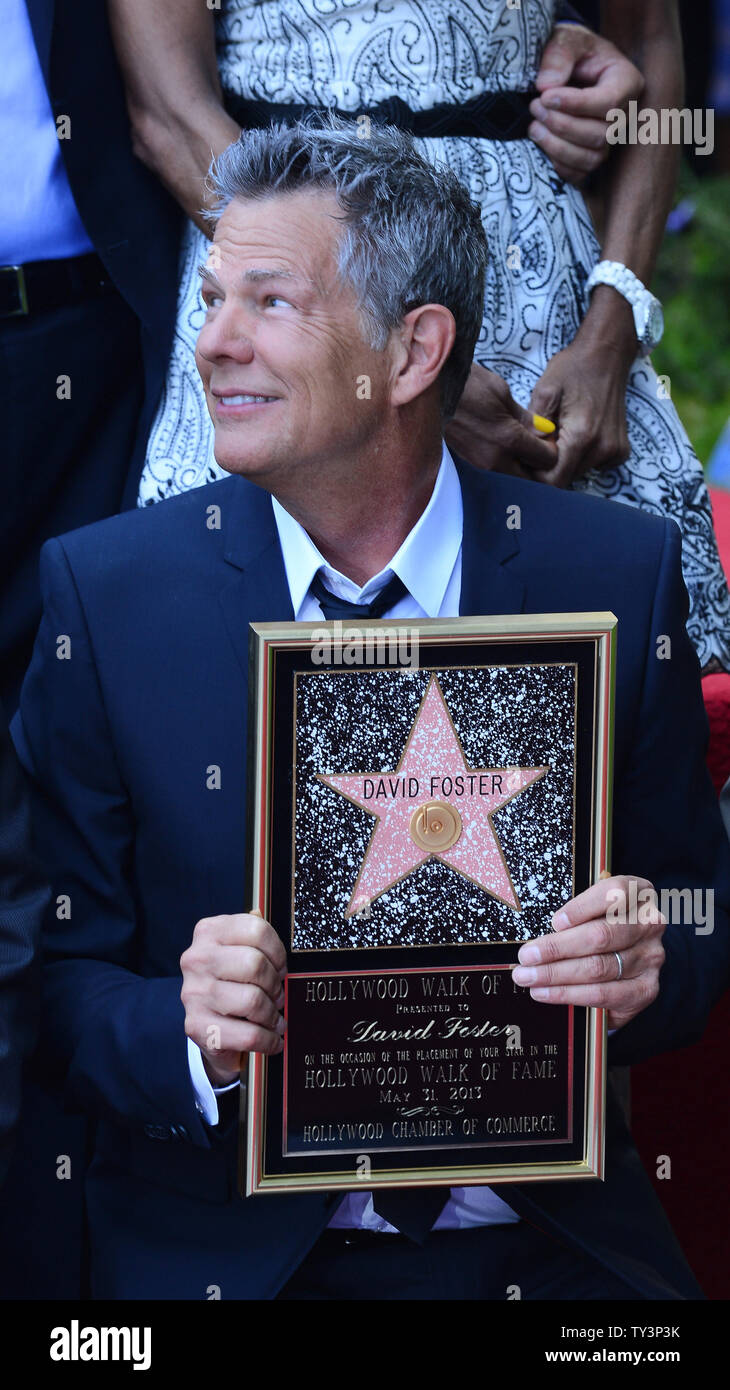 David Foster holds a replica plaque during an unveiling ceremony ...