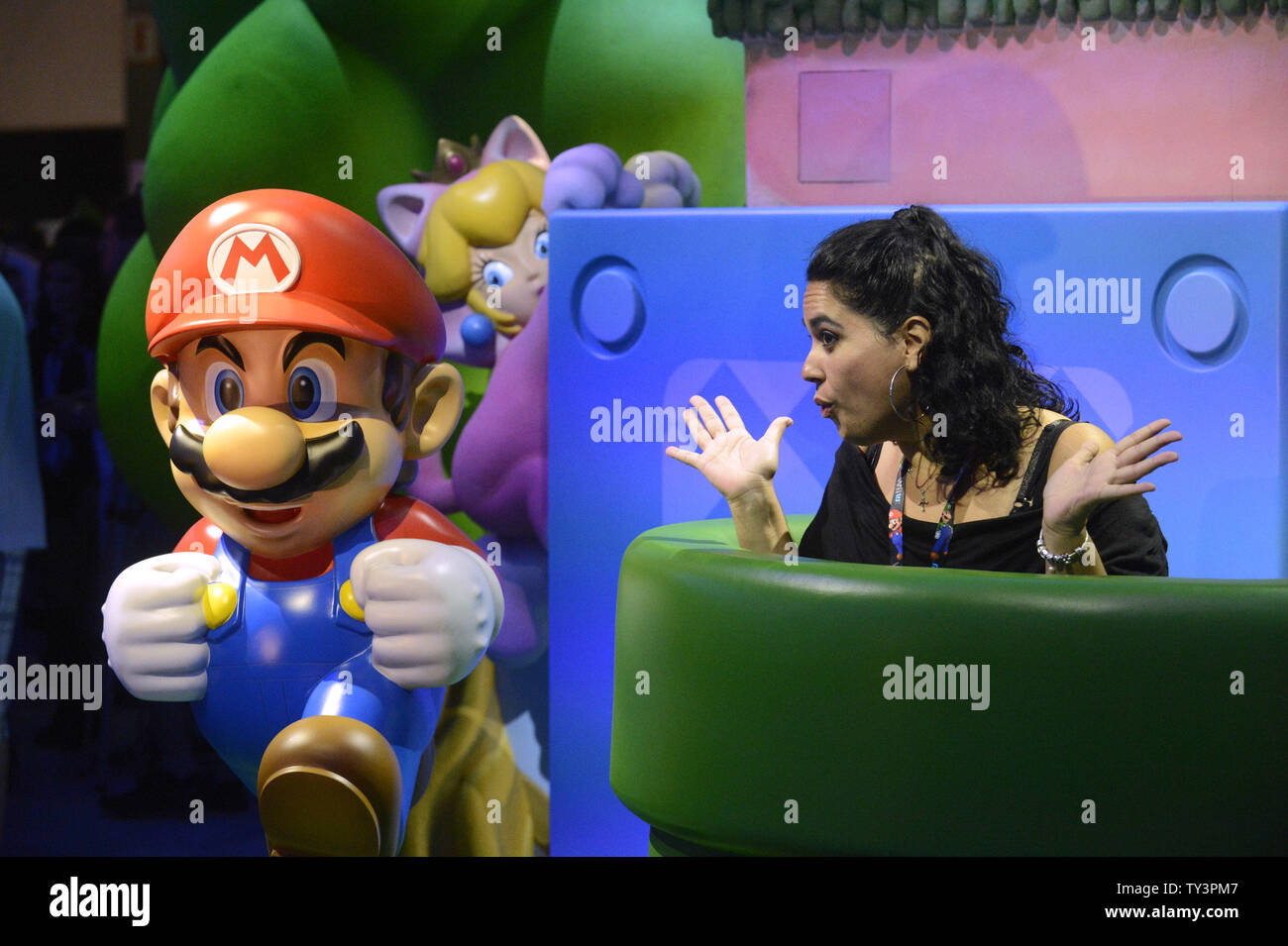 Attendees pose for pictures at the Super Mario 3D display during E3 ...