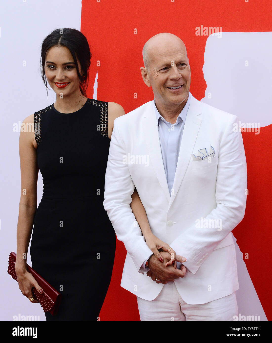 Cast member Bruce Willis and his wife Emma Heming attend the premiere ...