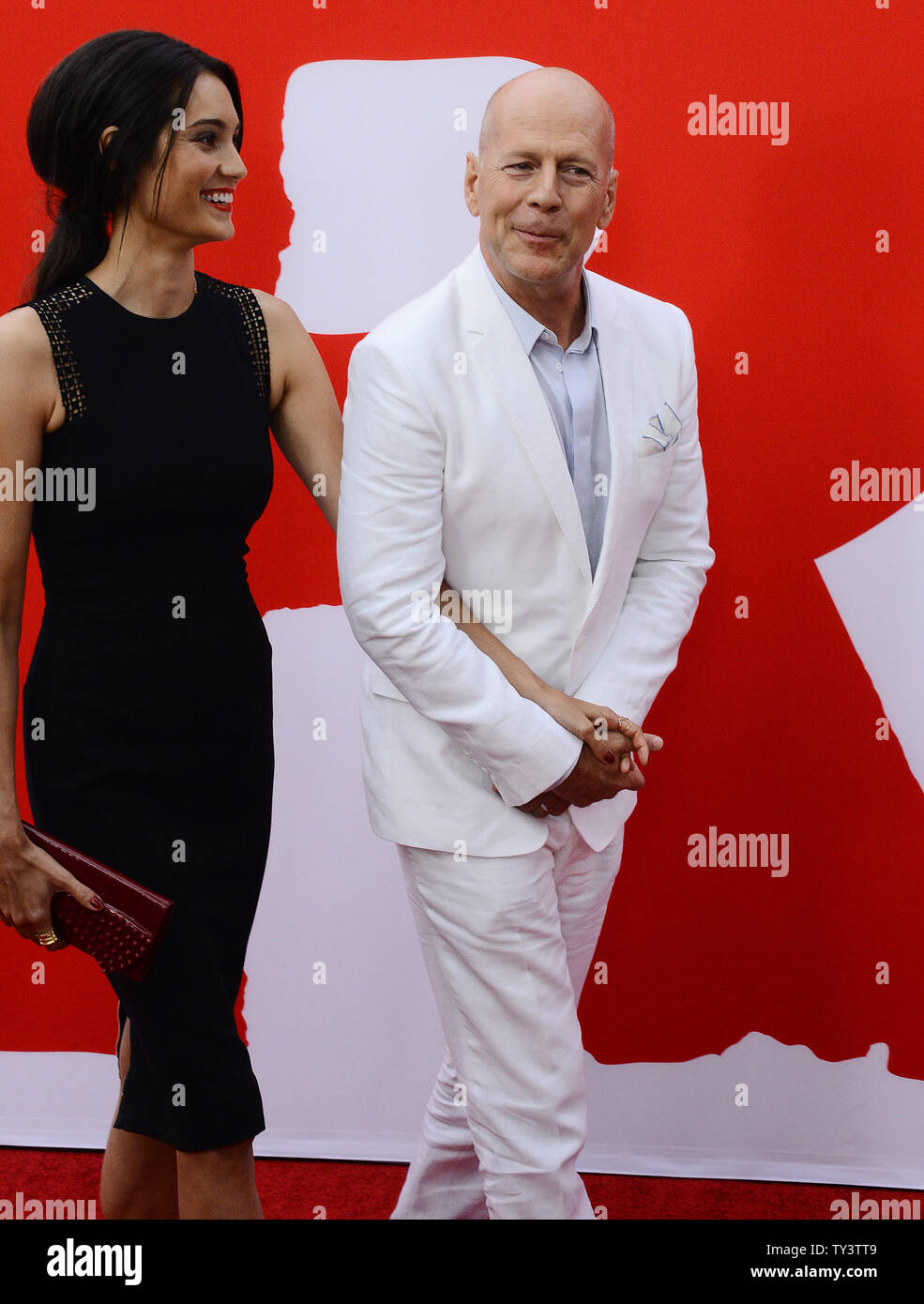 Cast member Bruce Willis and his wife Emma Heming attend the premiere ...