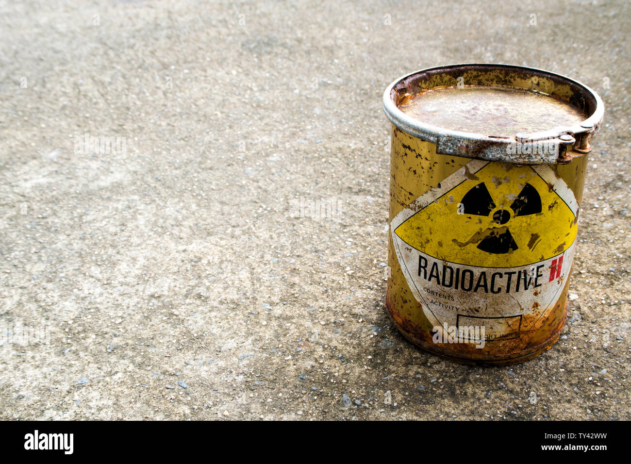 Radiation warning sign on a rusty package of the radioactive material ...