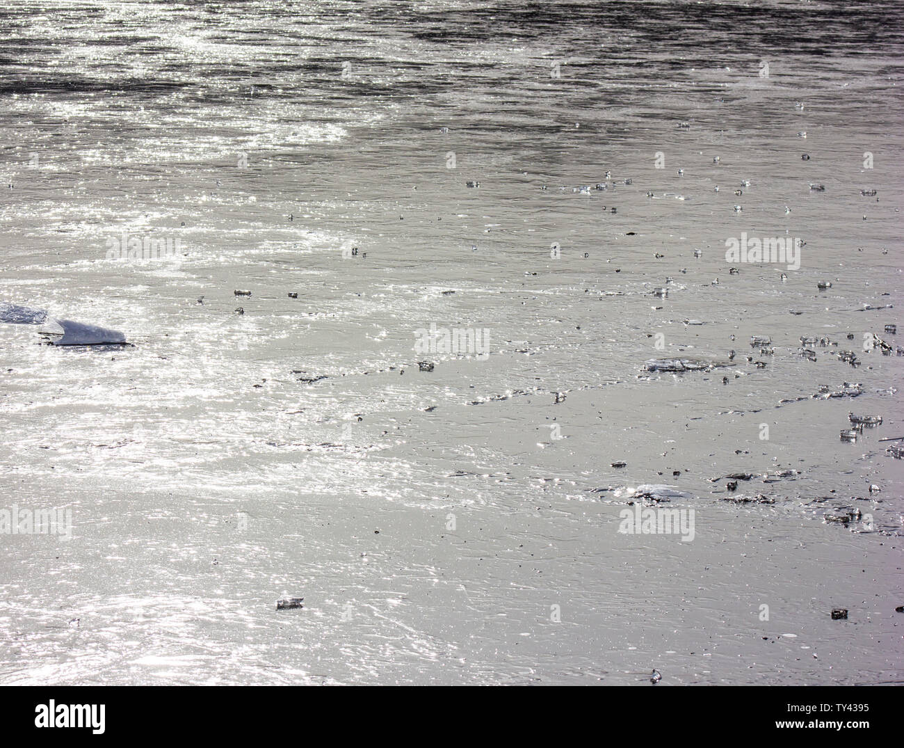 Beautiful frozen lake, covered with shattering ice.Ice cubes and broken ...