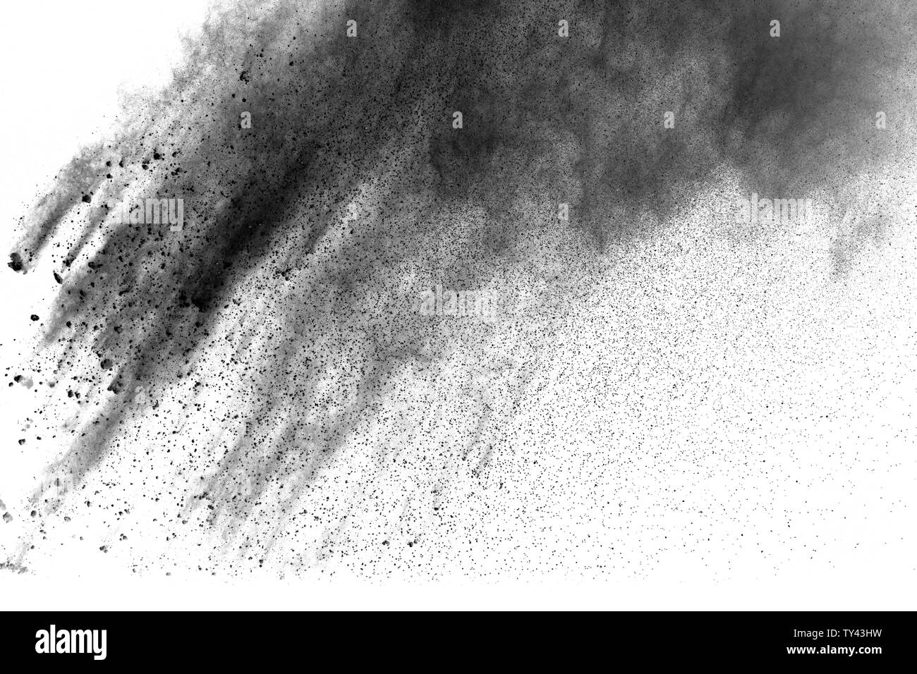 Black particles splattered on white background. Black powder dust ...