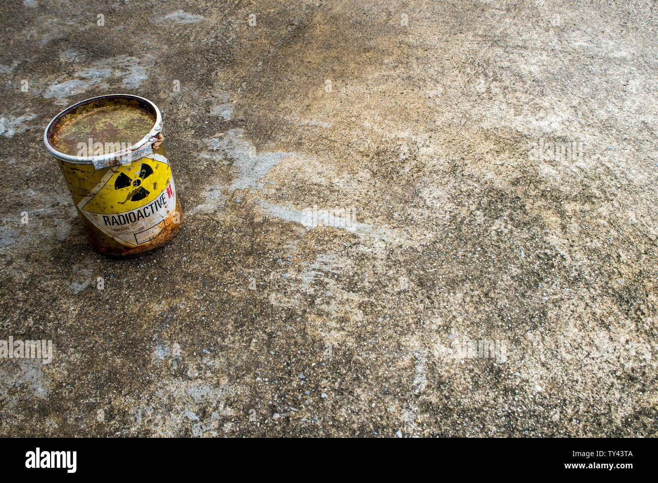 Radiation warning sign on a rusty package of the radioactive material ...