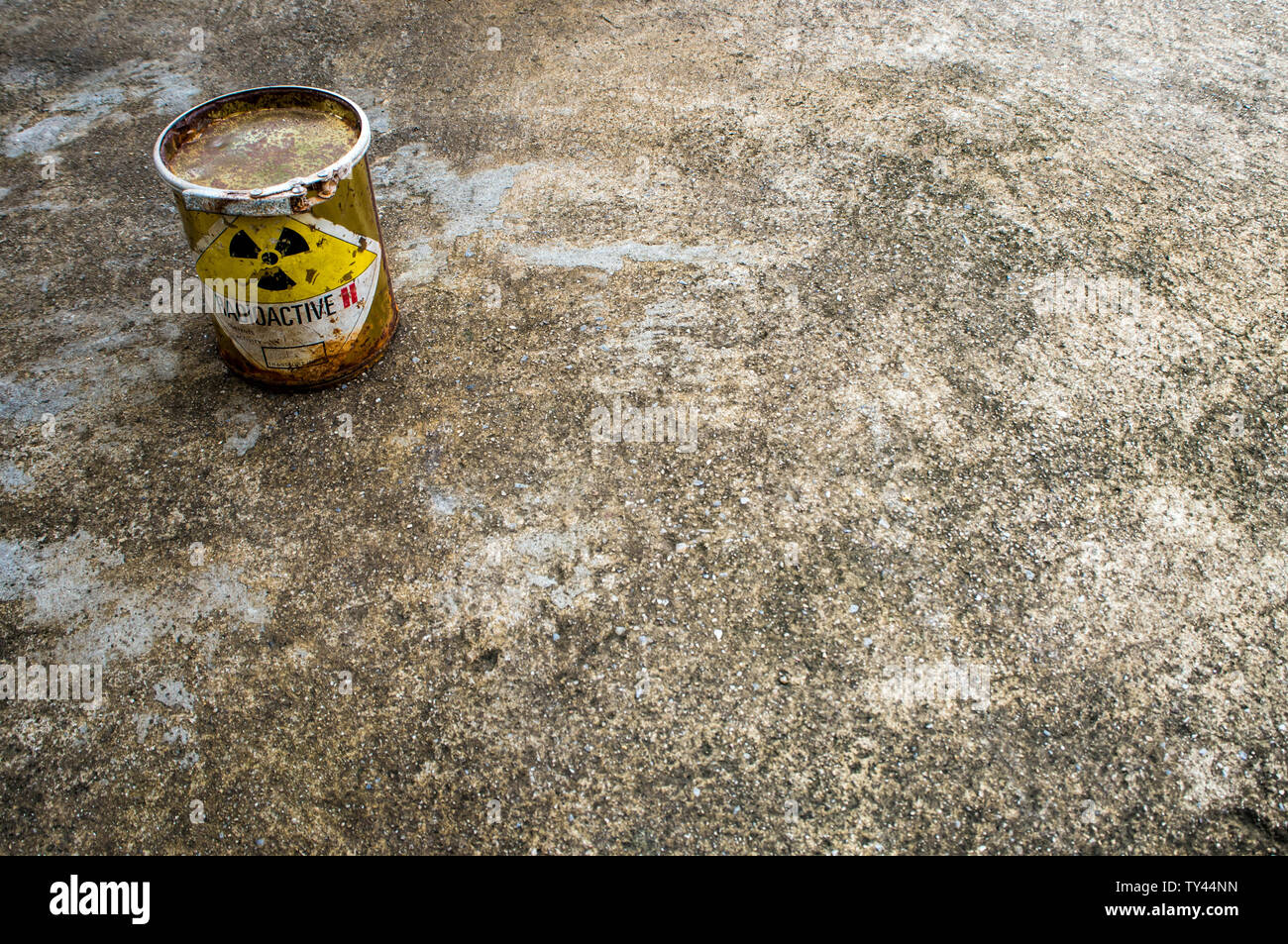 Radiation warning sign on a rusty package of the radioactive material ...