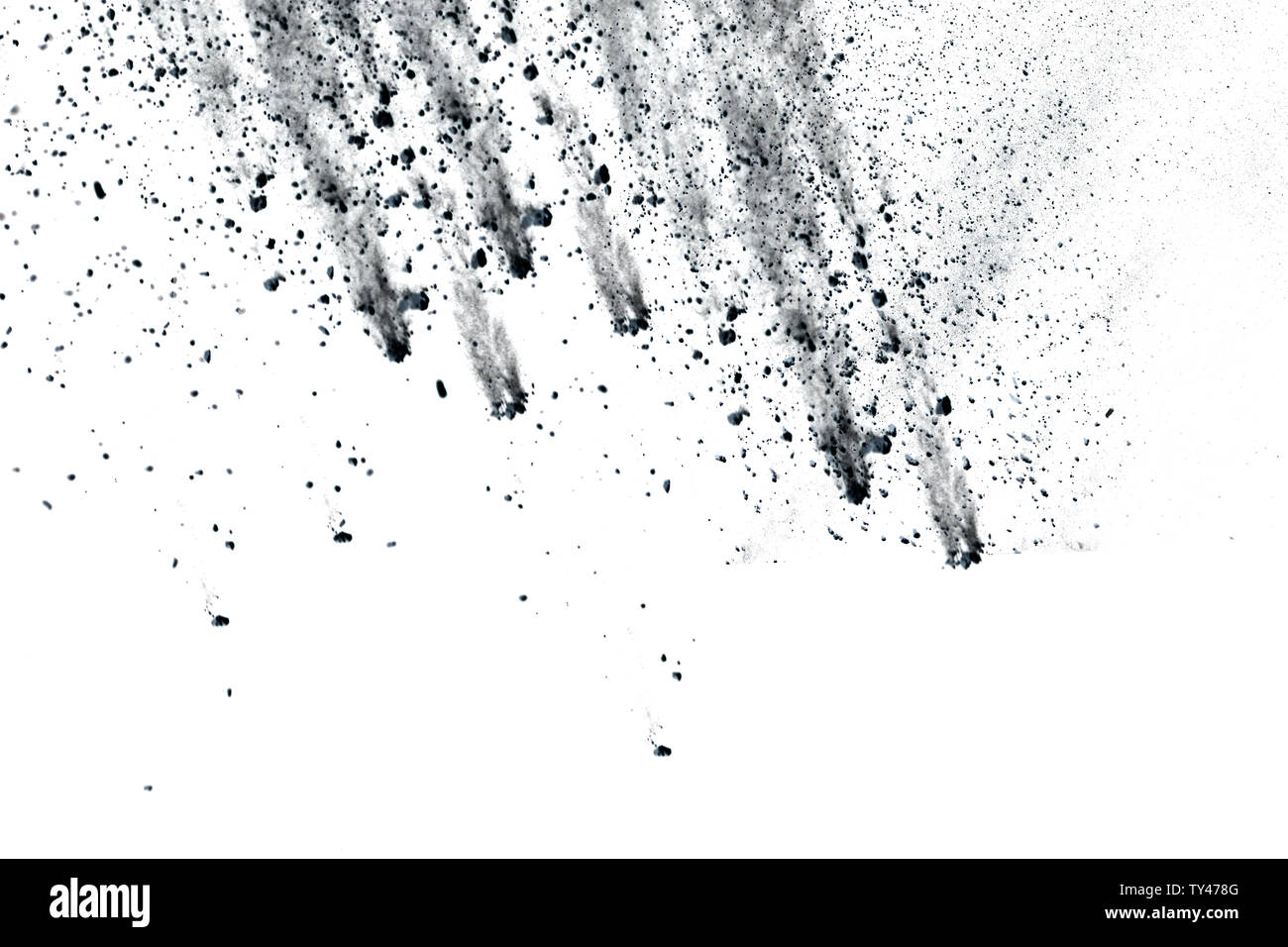 Black particles splattered on white background. Black powder dust ...
