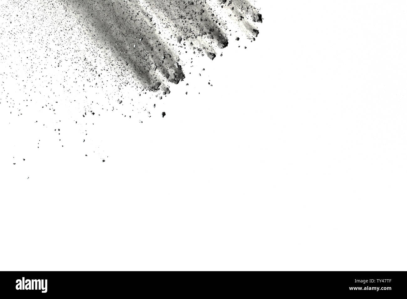 Black particles splattered on white background. Black powder dust ...