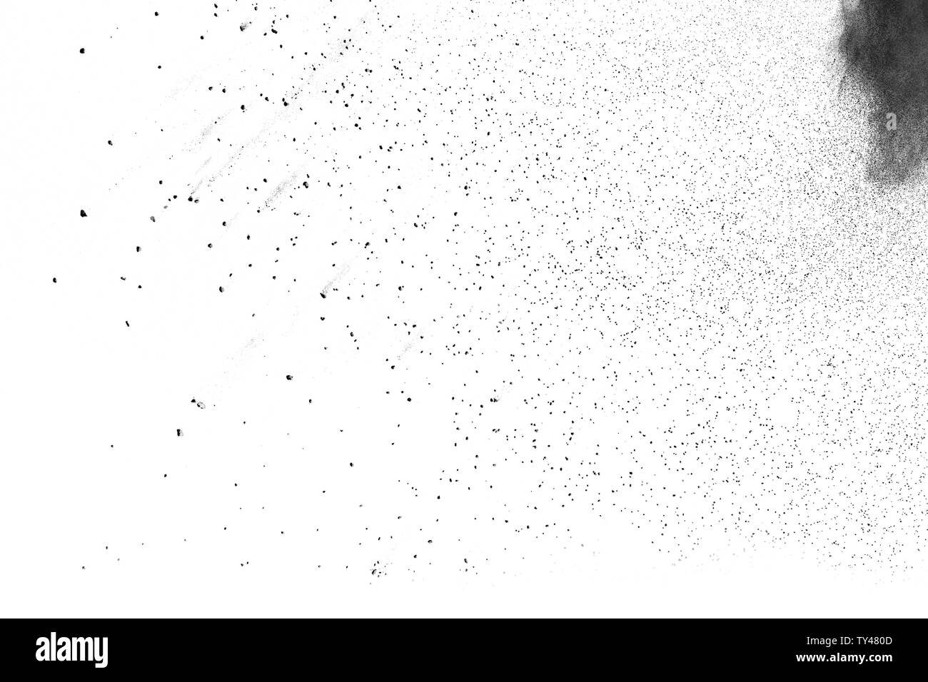 Black particles splattered on white background. Black powder dust ...