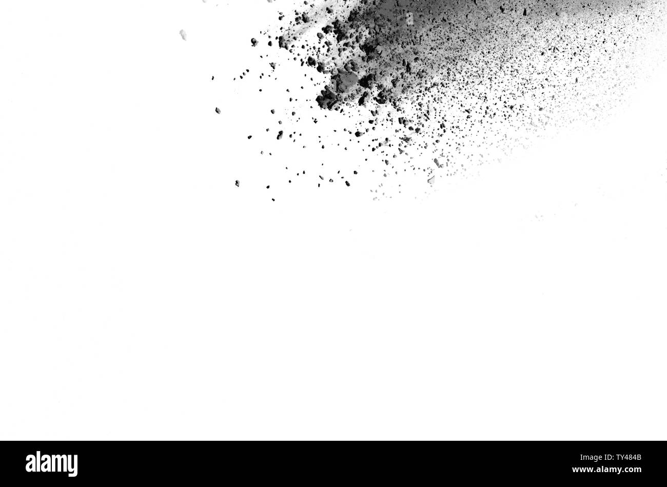Black particles splattered on white background. Black powder dust ...