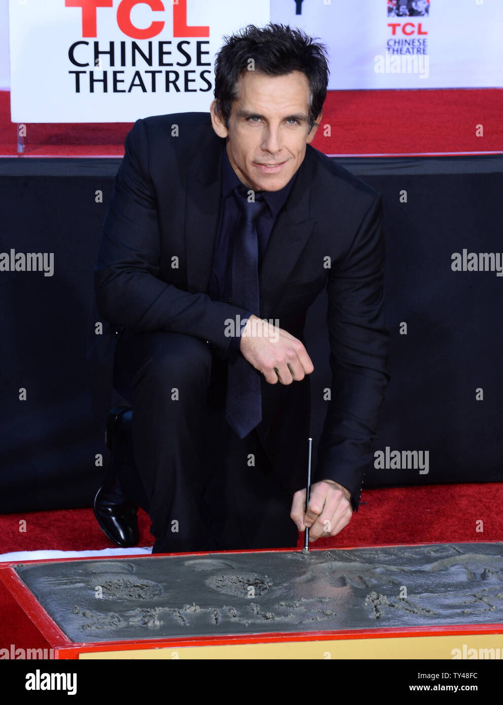Actor Ben Stiller signs his name in wet cement during his hand and ...