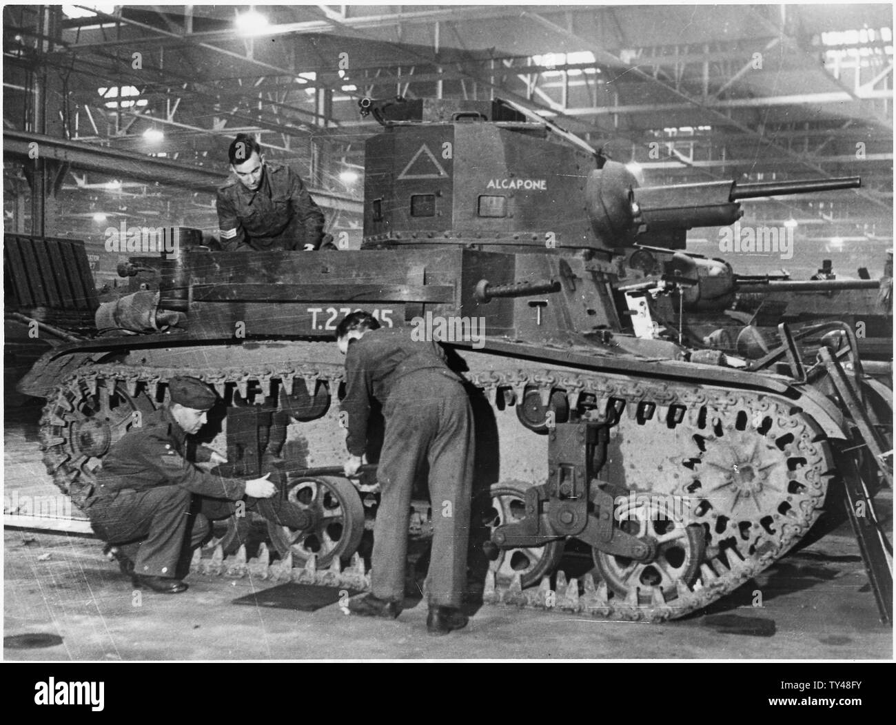 Fitters are at work assembling an American light tank which has just ...