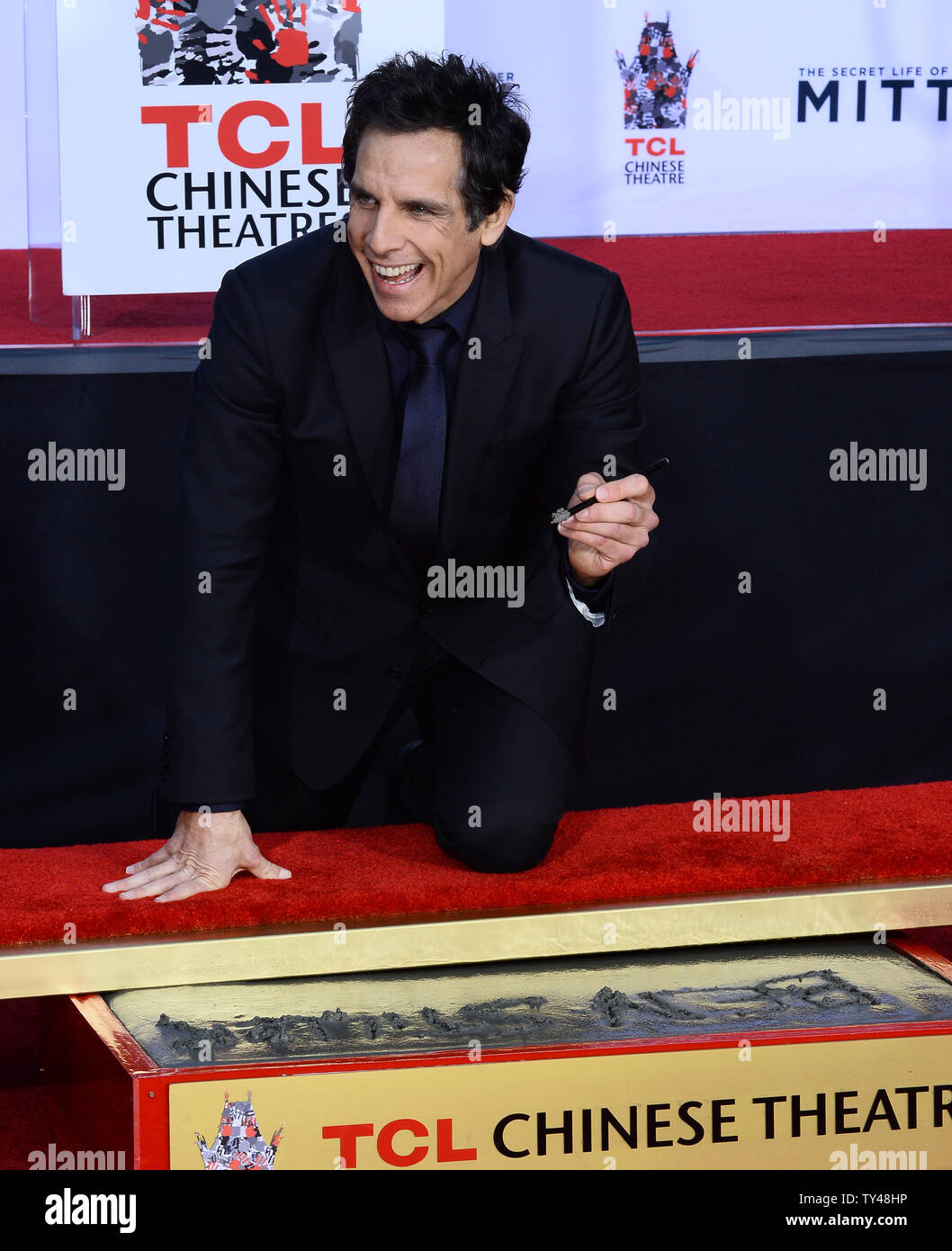 Actor Ben Stiller signs his name in wet cement during his hand and ...