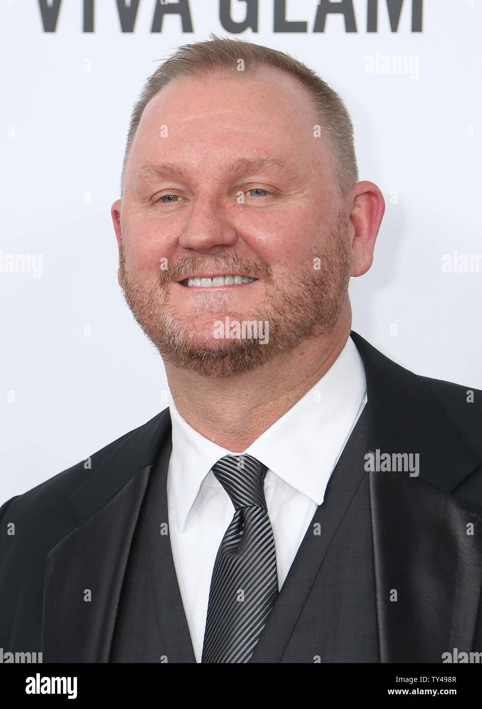 amFAR CEO Kevin Robert Frost arrives on the red carpet during the 2013 ...