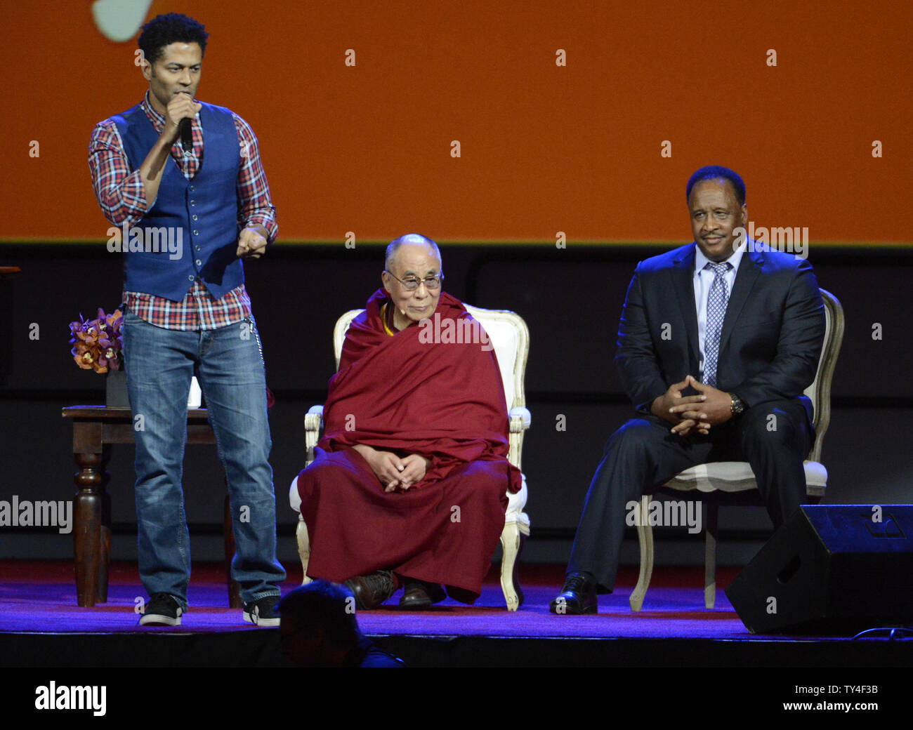 The Dalai Lama (C) listens with Inglewood Mayor James T. Butts (R) as ...