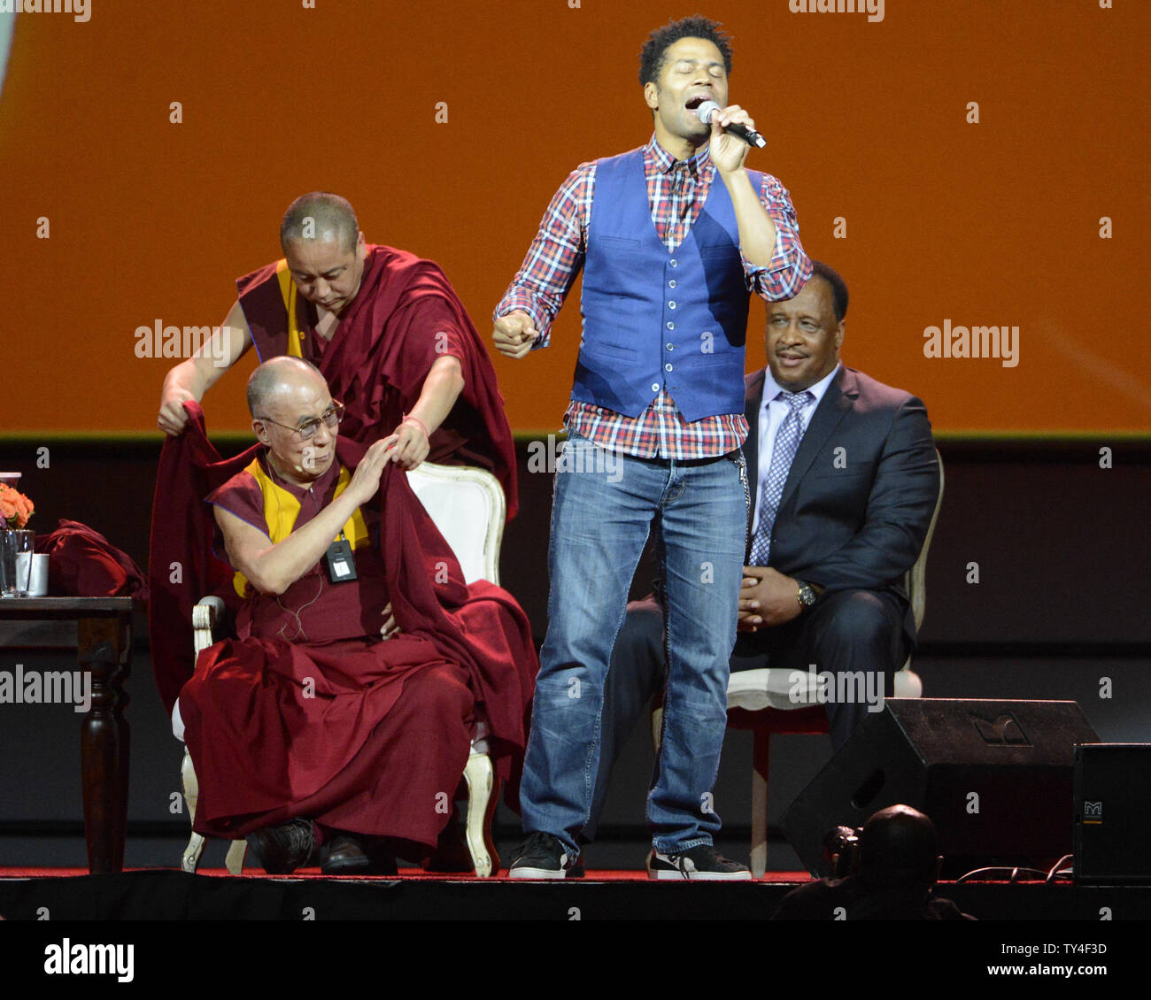 The Dalai Lama (L) listens with Inglewood Mayor James T. Butts (R) as ...
