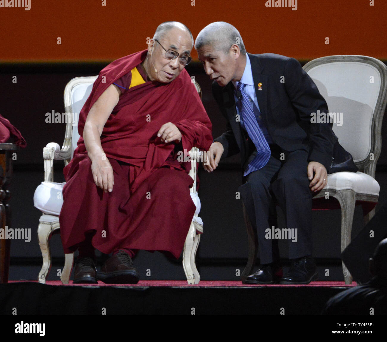 The Dalai Lama (L) listens to an interpreter before he speaks at the ...