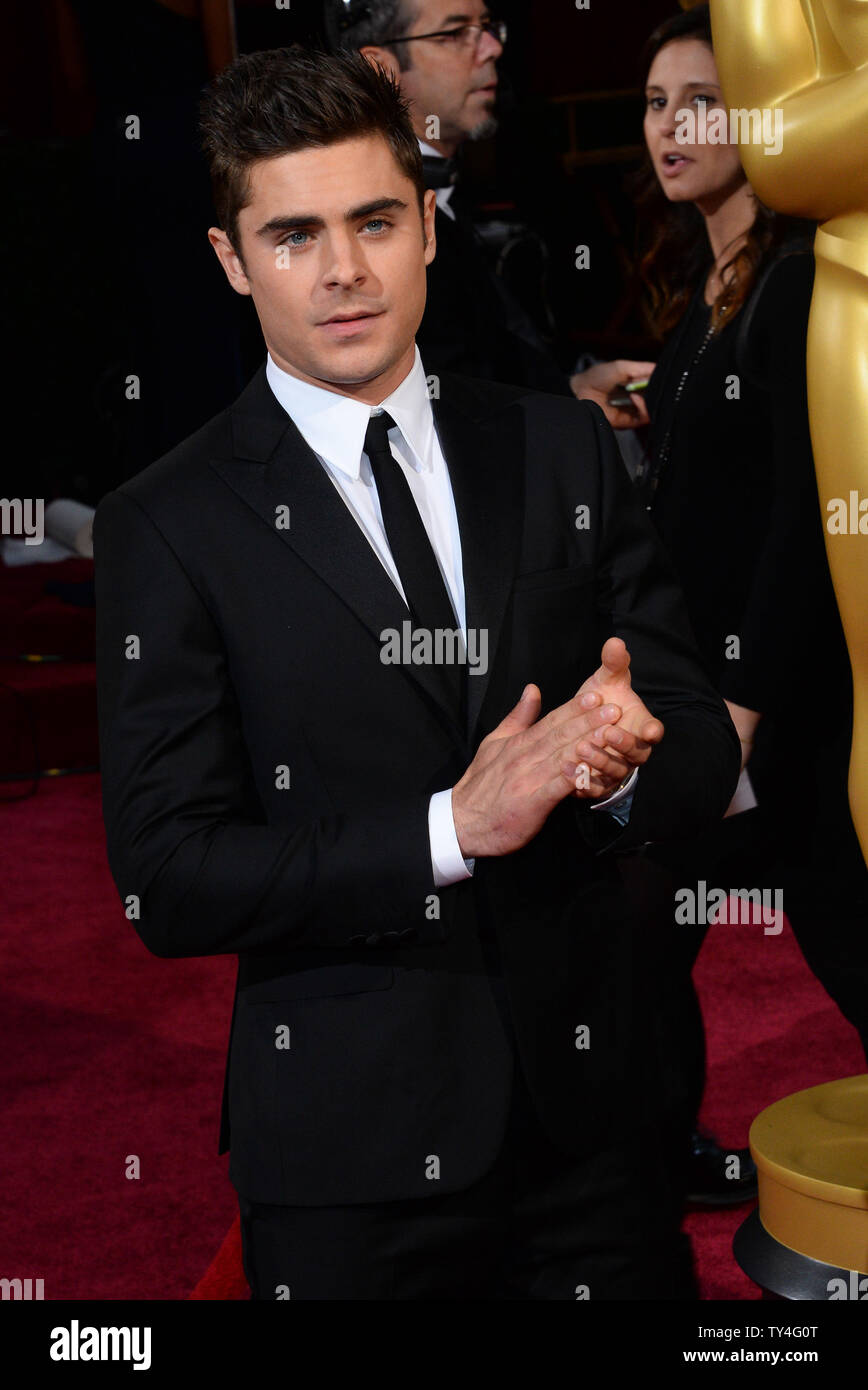 Actor Zac Efron arrives on the red carpet at the 86th Academy Awards at ...
