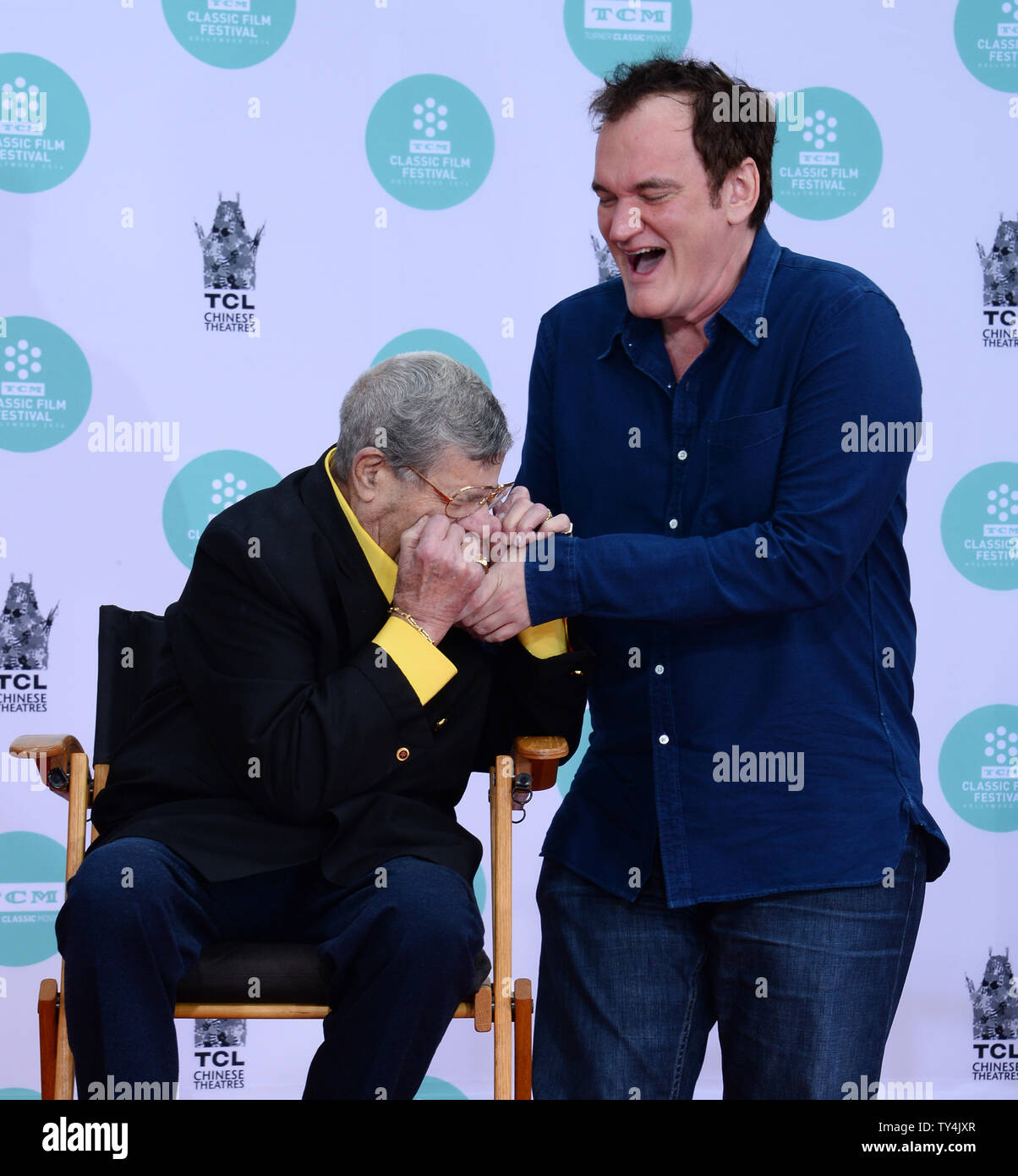Actor Jerry Lewis is joined by director Quentin Tarantino in a hand ...