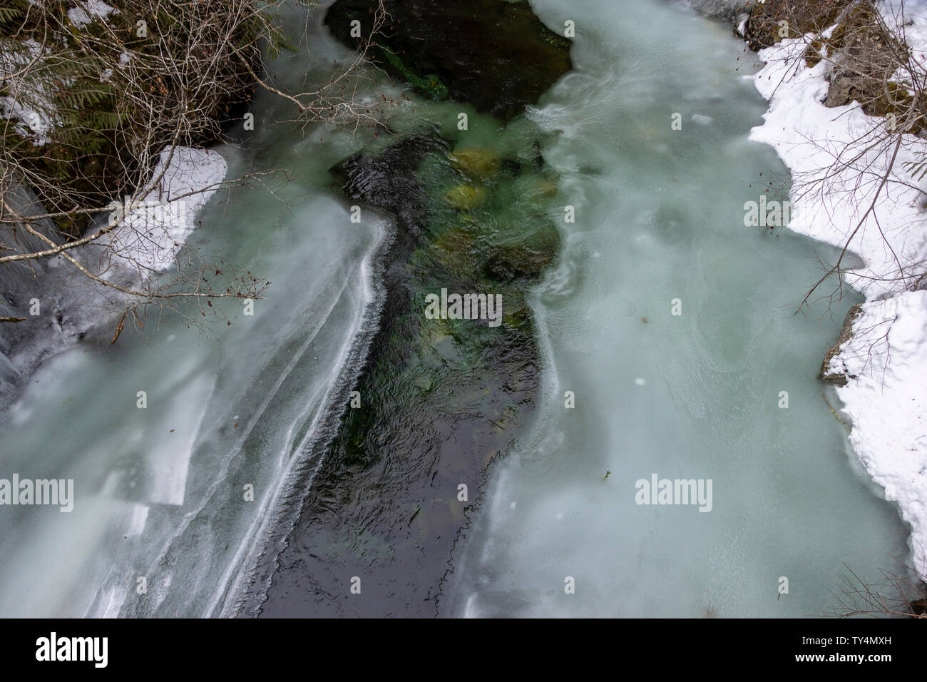 Green water in river merges beautifully with white ice and snow in the ...