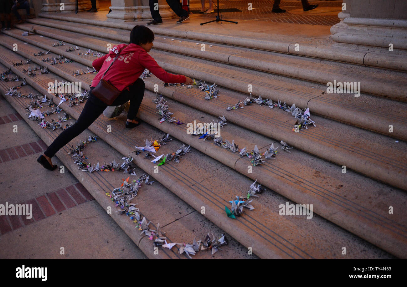 A woman places cranes on the steps of Royce Hall as a gesture of peace ...