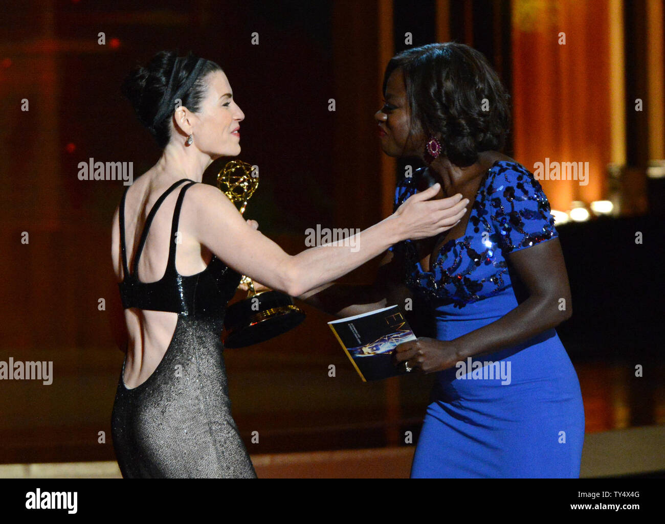 Viola Davis, right, presents Julianna Margulies with the award for ...