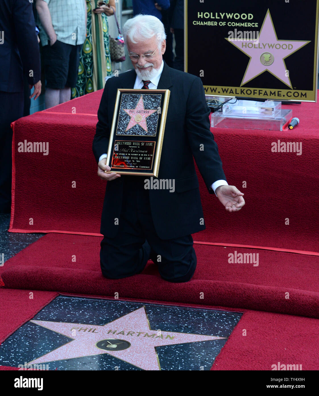 John Hartmann holds a replica plaque during a Hollywood Walk of Fame ...