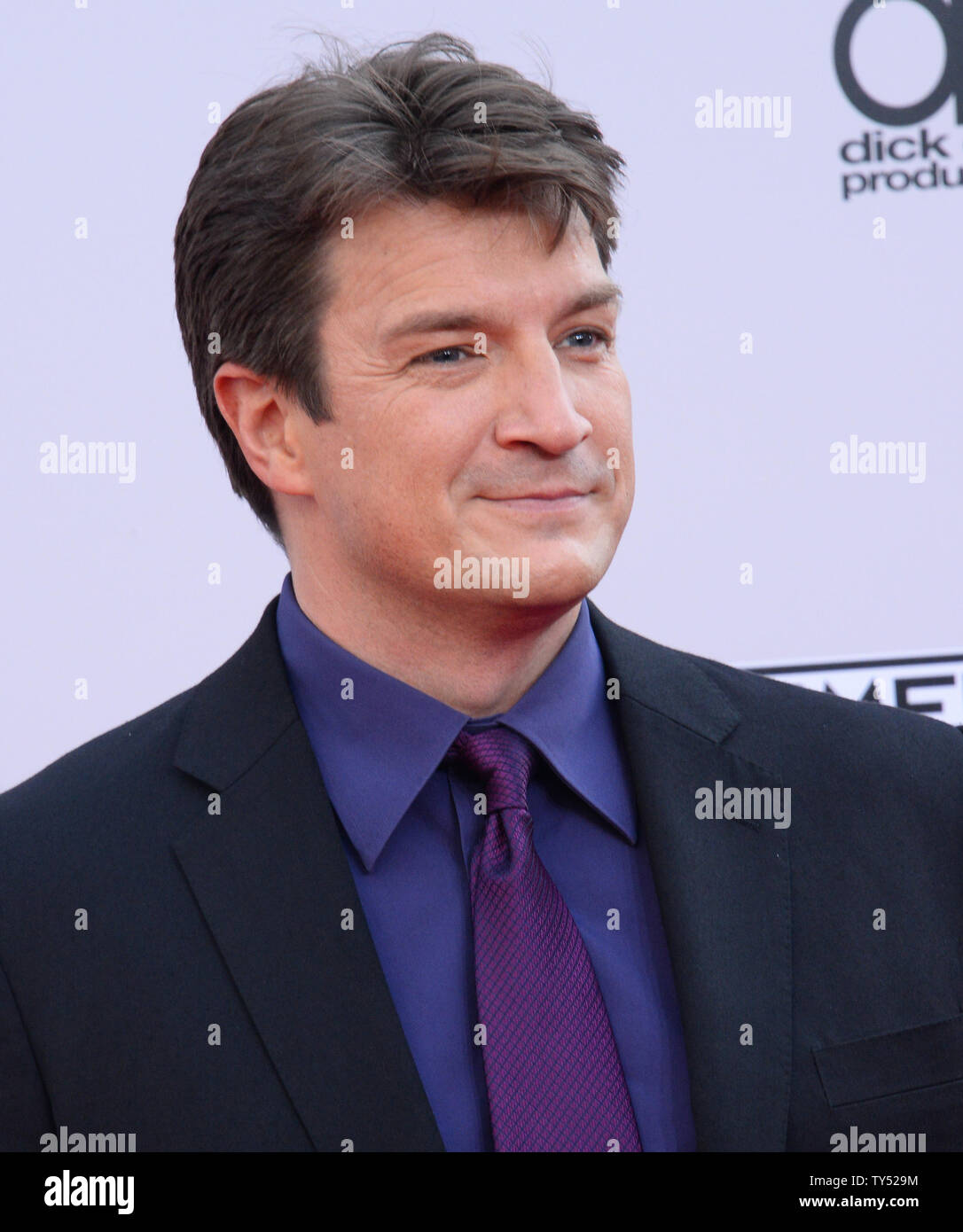Actor Nathan Fillion arrives for the 42nd annual American Music Awards ...