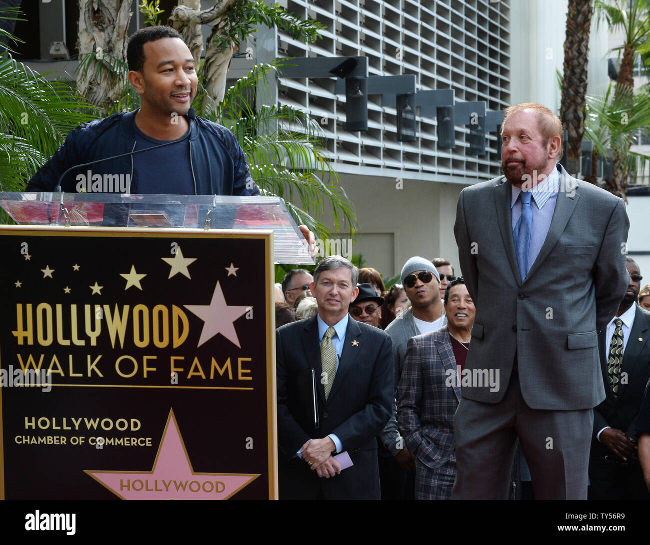 Television producer Ken Ehrlich (R) listens to comments by singer John ...