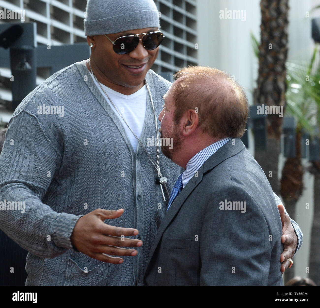 Television producer Ken Ehrlich (R) is congratulated by singer LL Cool ...