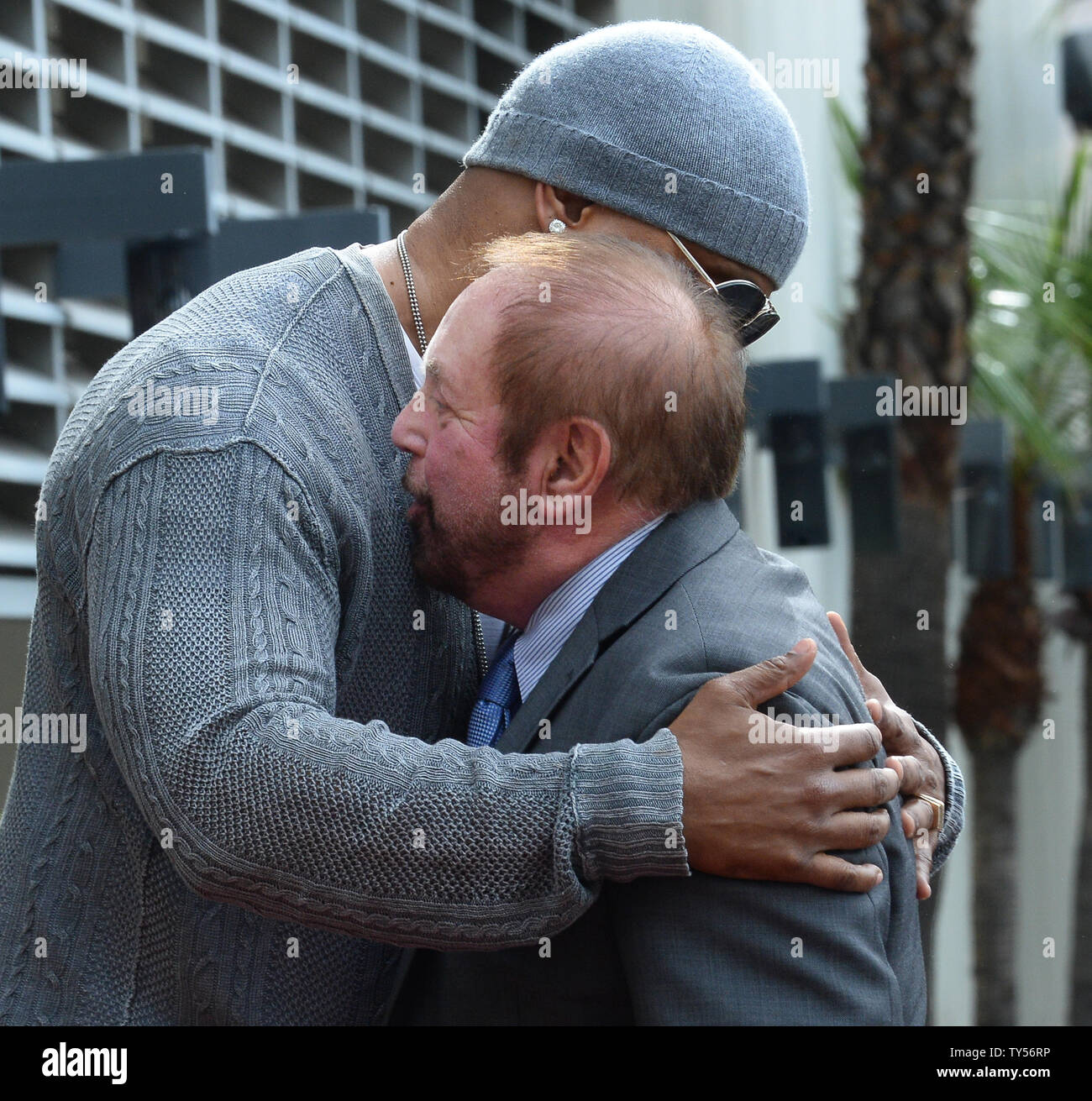 Television producer Ken Ehrlich (R) is congratulated by singer LL Cool ...