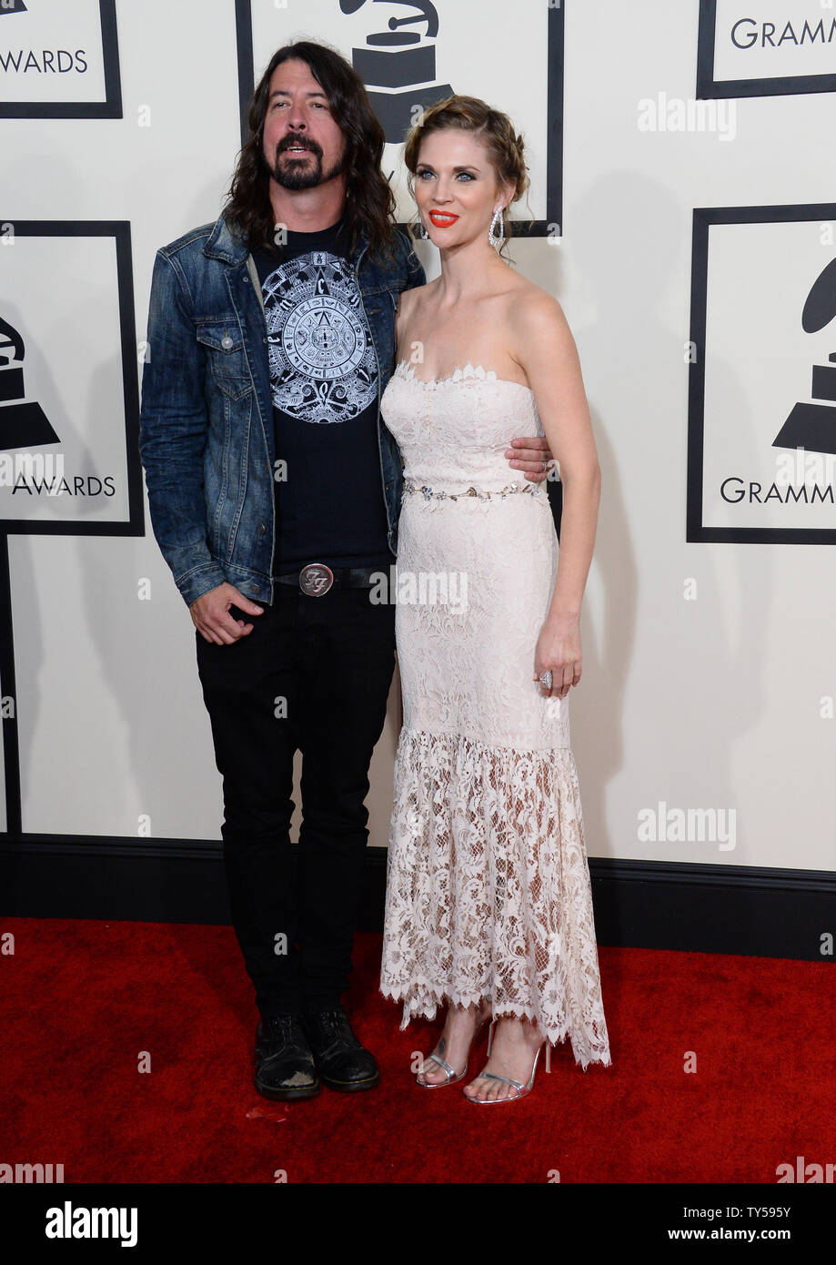 Musician Dave Grohl , left, and Jordyn Blum arrive for the 57th Grammy ...