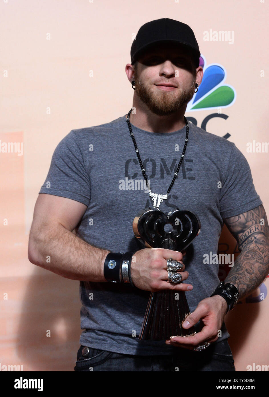 Singer Brantley Gilbert poses backstage with the Renegade award at the ...
