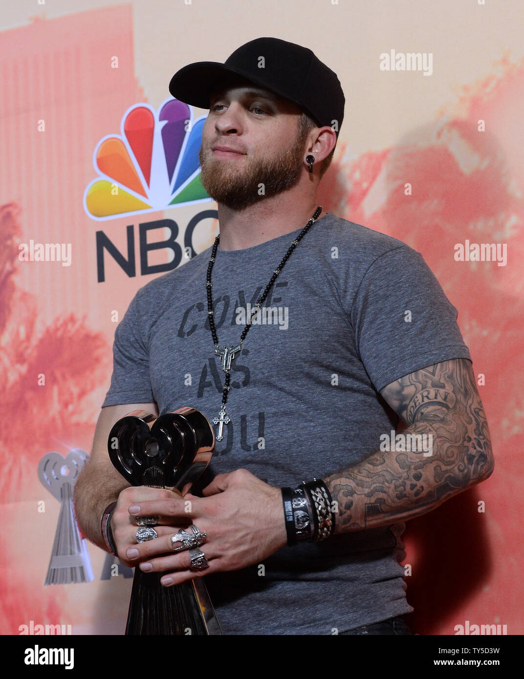 Singer Brantley Gilbert poses backstage with the Renegade award at the ...