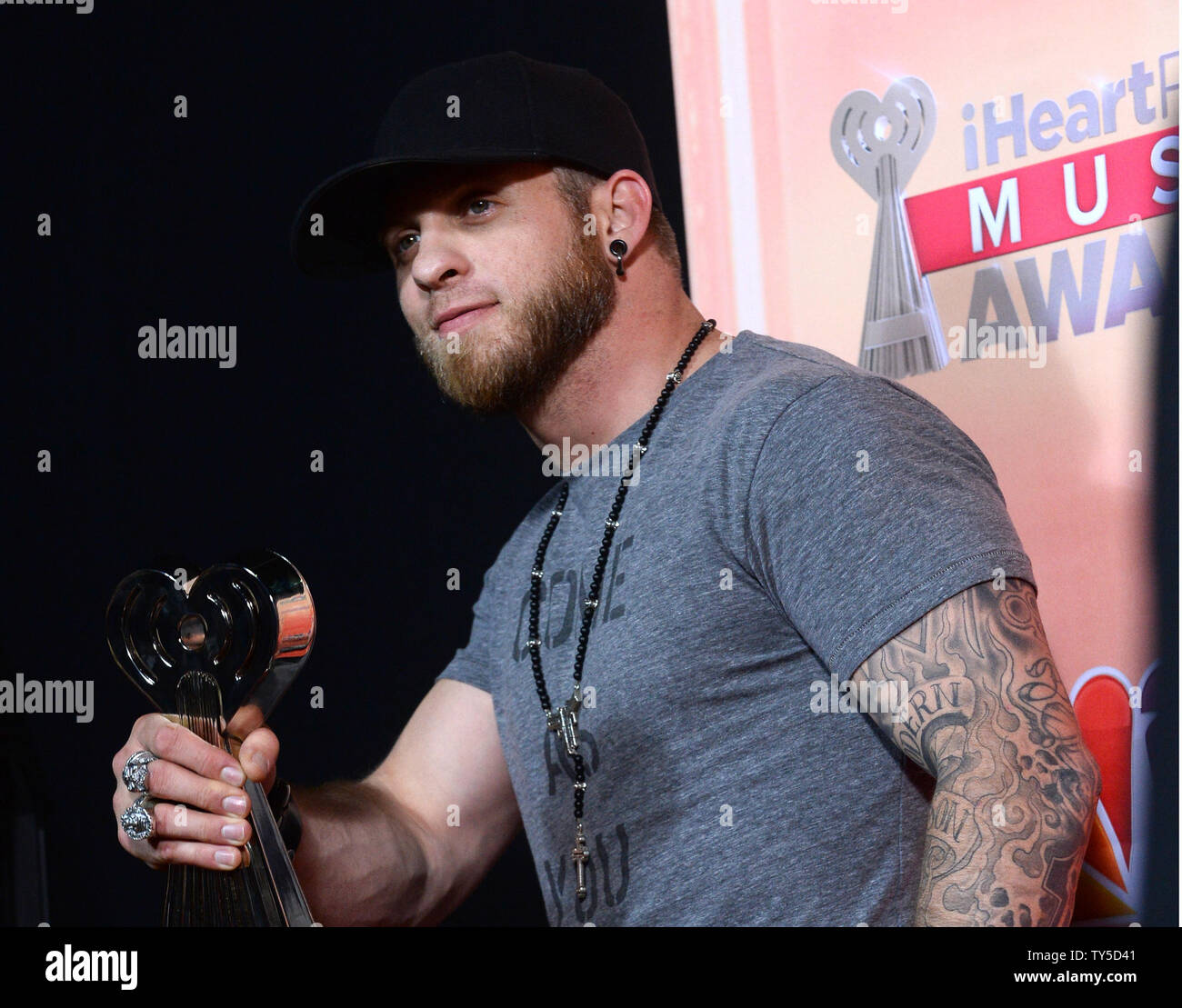 Singer Brantley Gilbert poses backstage with the Renegade award at the ...