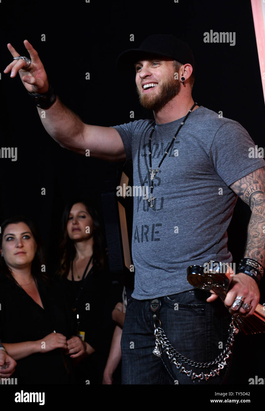 Singer Brantley Gilbert poses backstage with the Renegade award at the ...