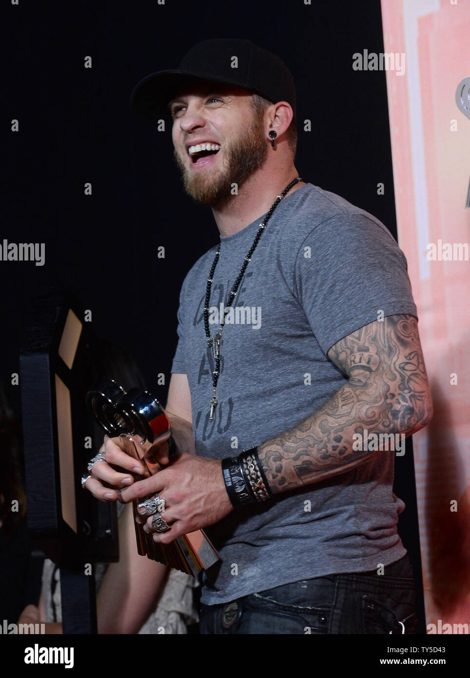 Singer Brantley Gilbert poses backstage with the Renegade award at the ...