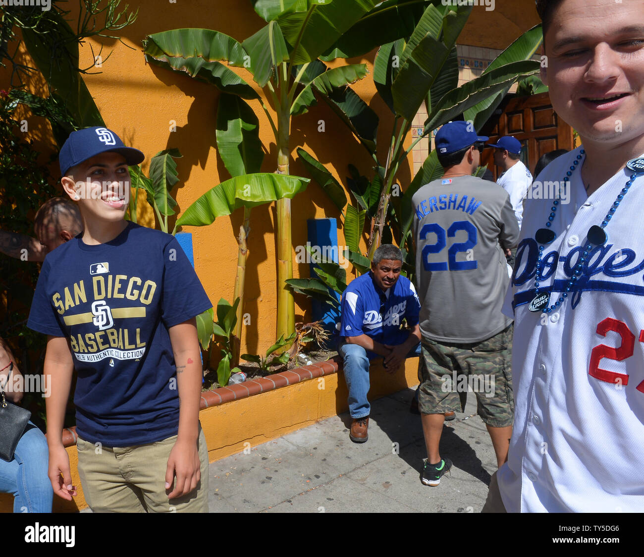 An overflow group of fans gather outside a bar on Sunset Blvd. near ...