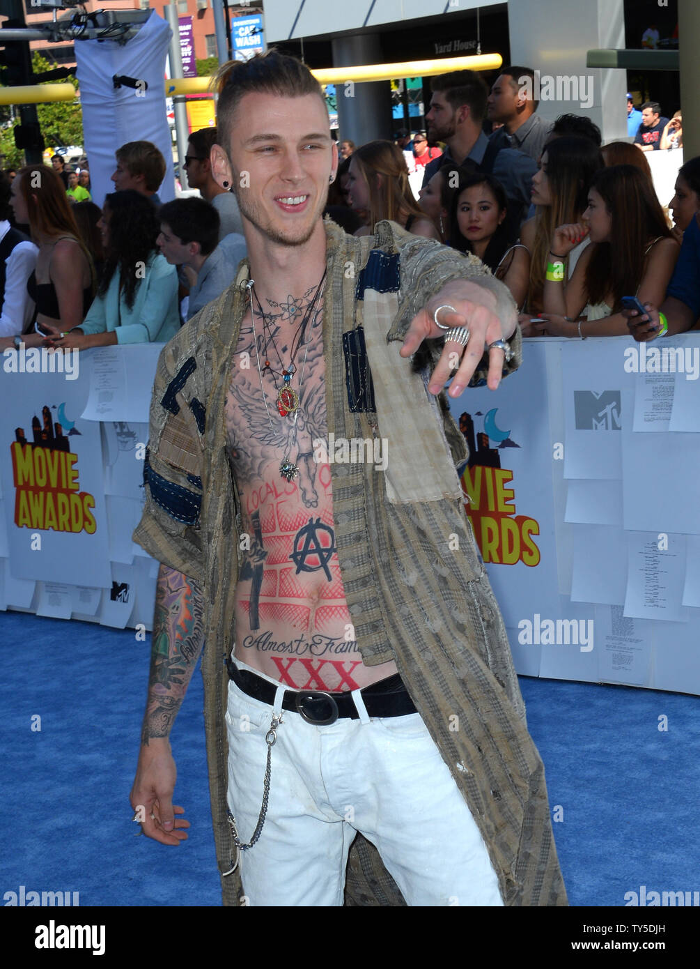 Rapper Machine Gun Kelly arrives for the MTV Movie Awards at Nokia ...