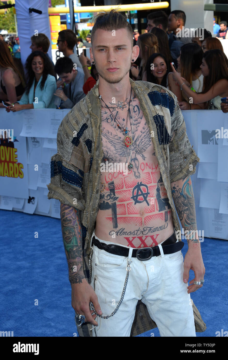 Rapper Machine Gun Kelly arrives for the MTV Movie Awards at Nokia ...