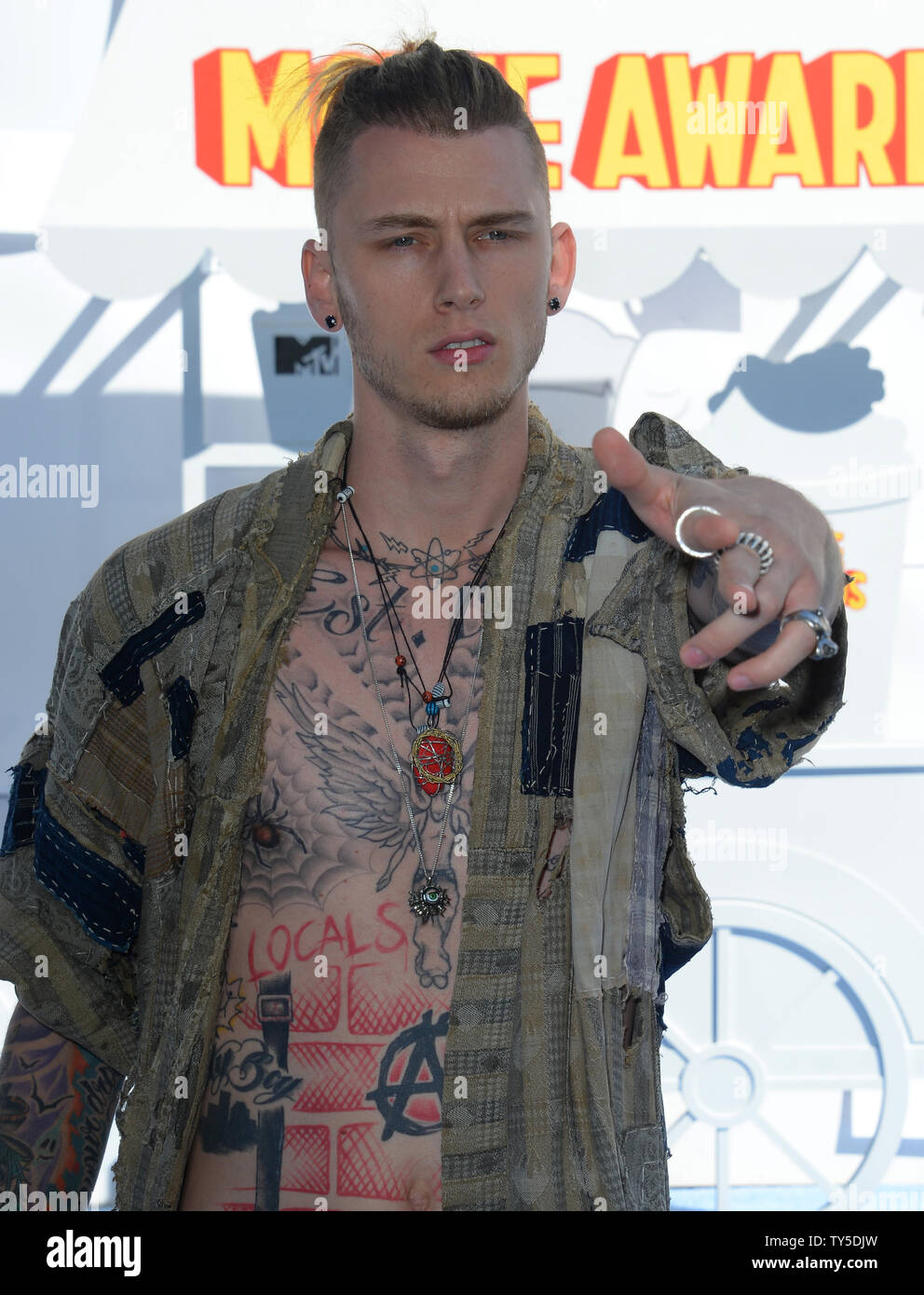 Rapper Machine Gun Kelly arrives for the MTV Movie Awards at Nokia ...