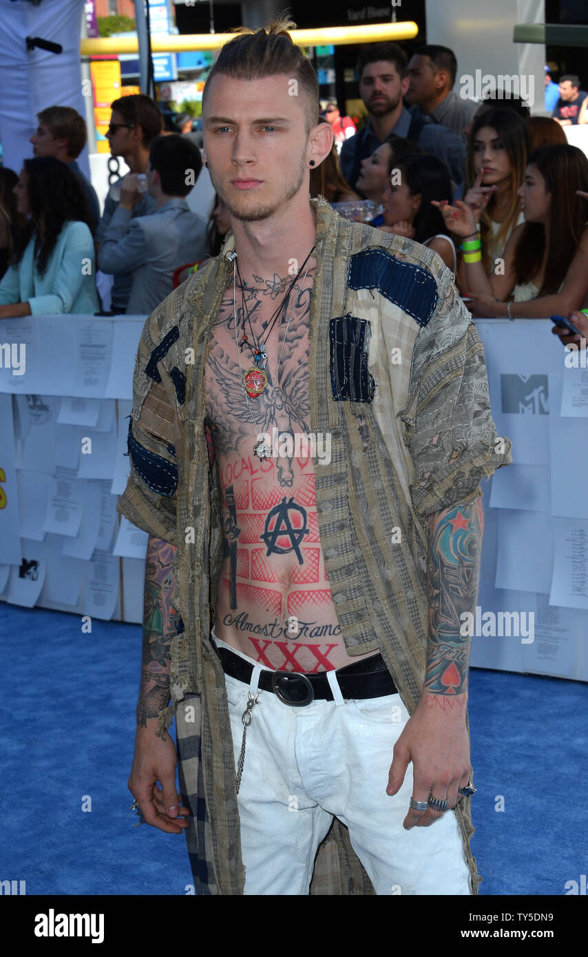 Rapper Machine Gun Kelly arrives for the MTV Movie Awards at Nokia ...