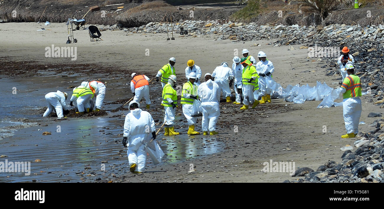 Workers continue the cleanup along Refugio Beach as efforts continue to ...